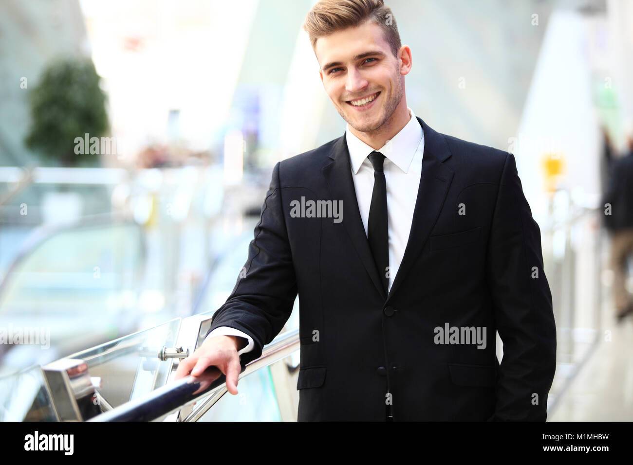 Handsome smiling confident businessman portrait Stock Photo - Alamy