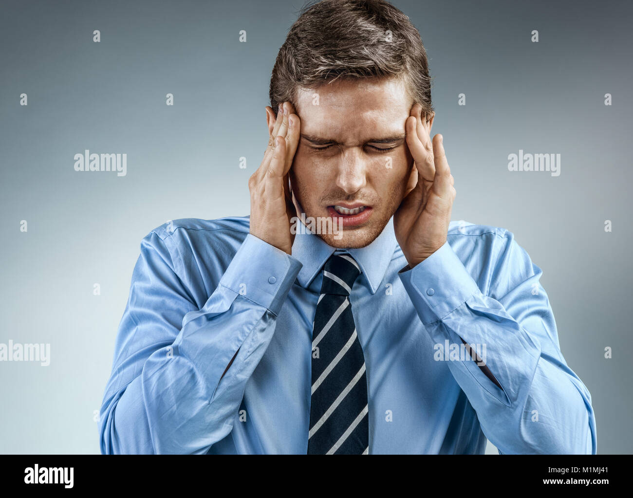 Young businessman with pain in his temples. Photo of man suffering from ...
