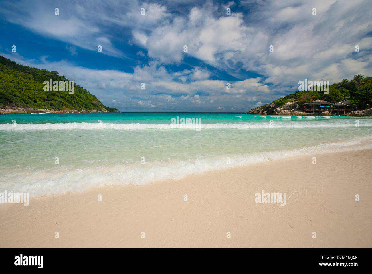 The empty paradise-like beach of Siam Bay, flanked by hills, on Ko ...