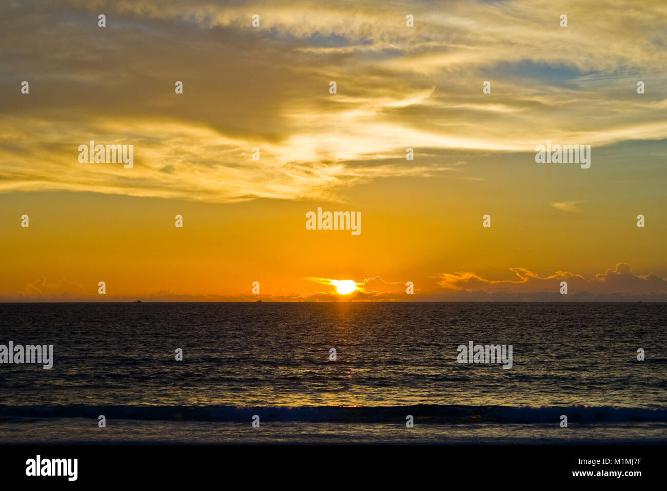 A beautiful sunset with clouds at Patok Beach on Racha Island, Phuket ...