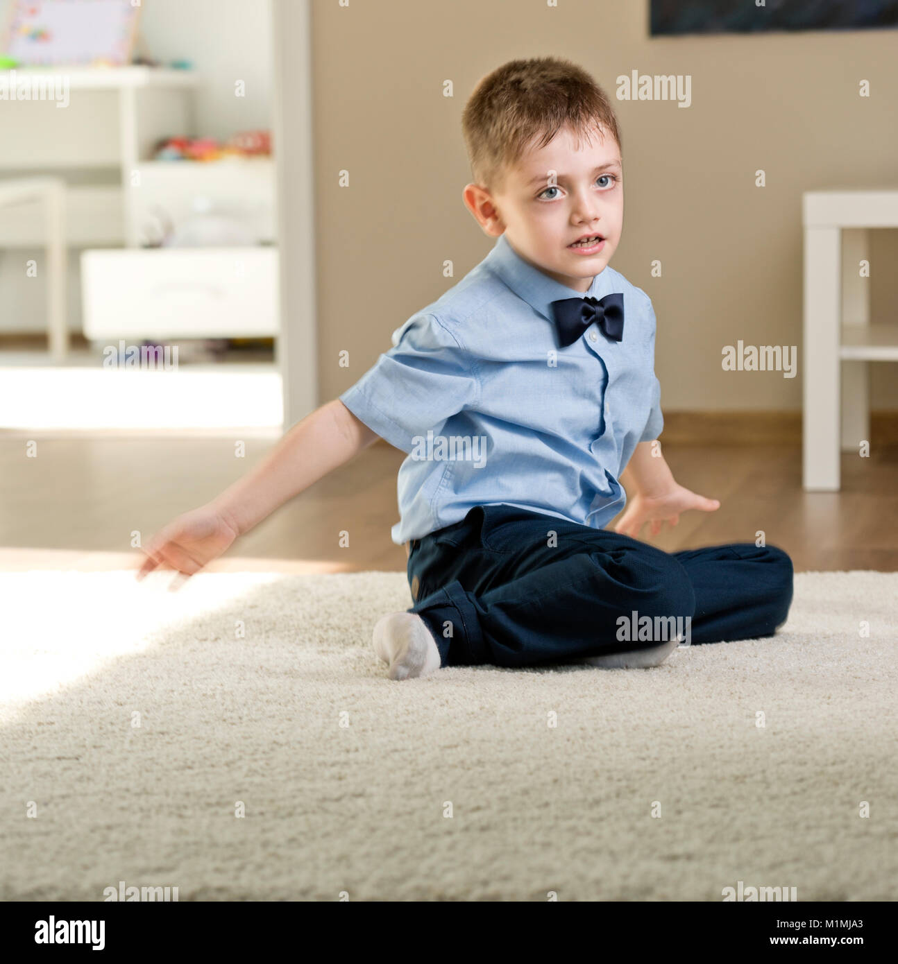 Six years old boy preparing for his first day of school, in blue shirt ...