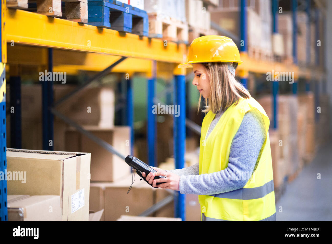 Warehouse woman worker with barcode scanner Stock Photo - Alamy