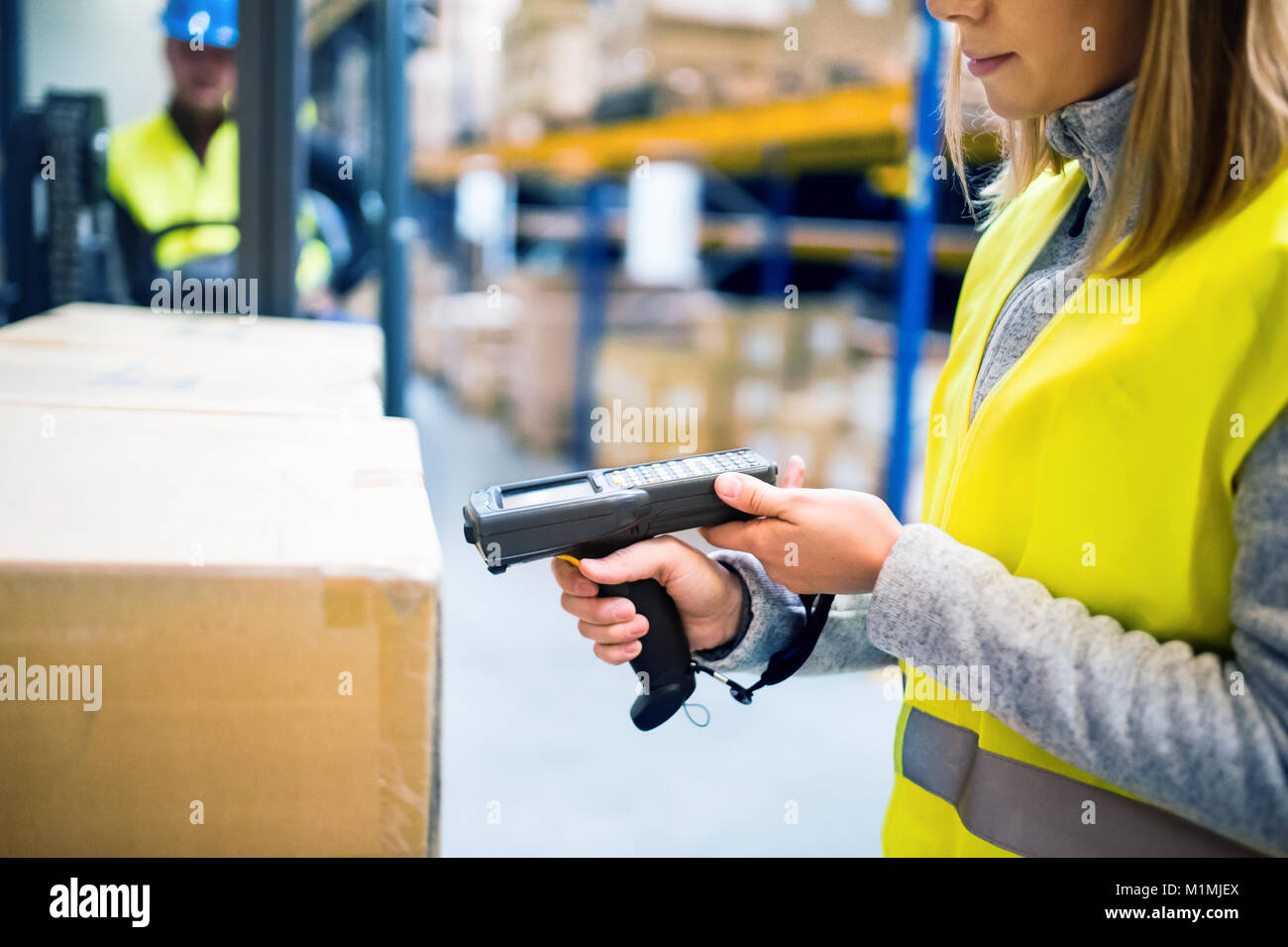 Warehouse woman worker with barcode scanner Stock Photo - Alamy
