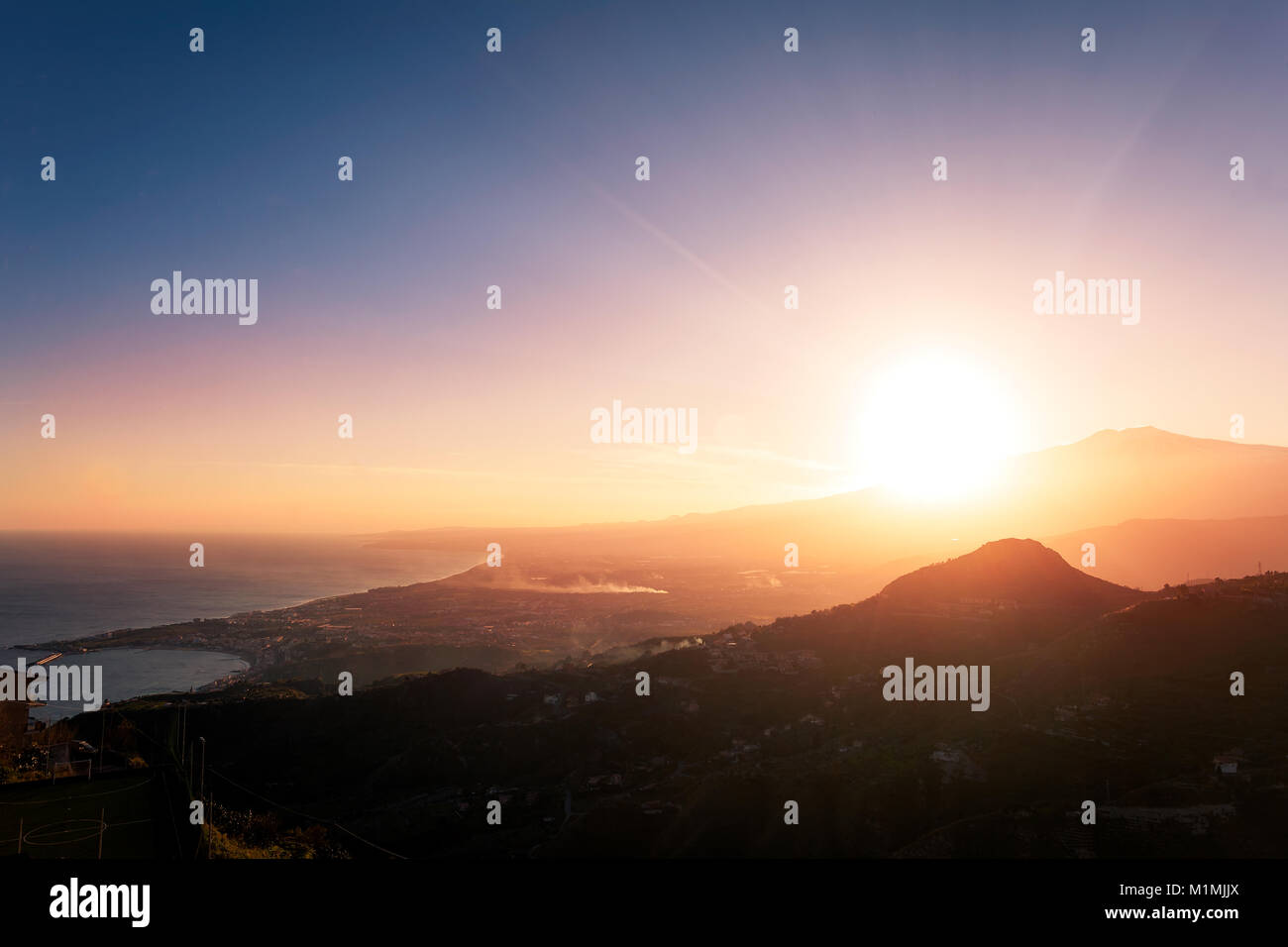 Sunset over Mount Etna and the gulf of Catania viewed from Taormina ...