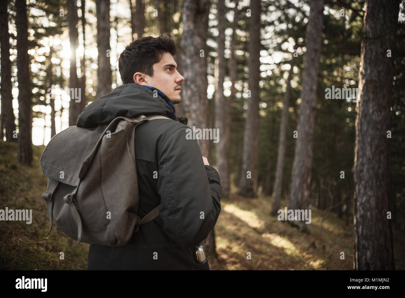 Young man carrying a backpack hi-res stock photography and images - Alamy