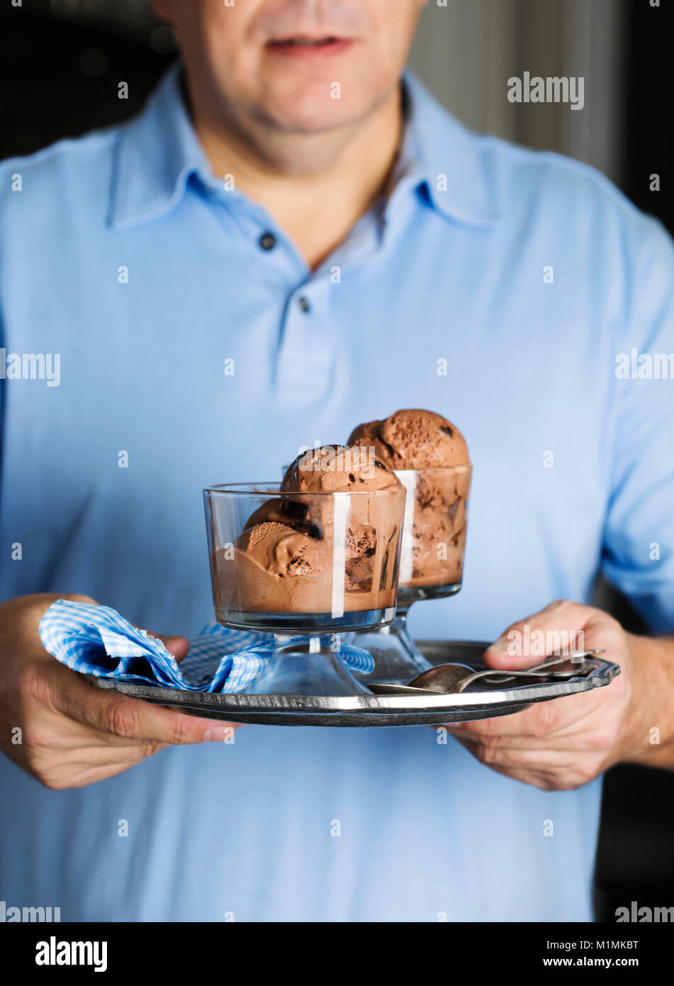Man serving chocolate ice-cream Stock Photo - Alamy
