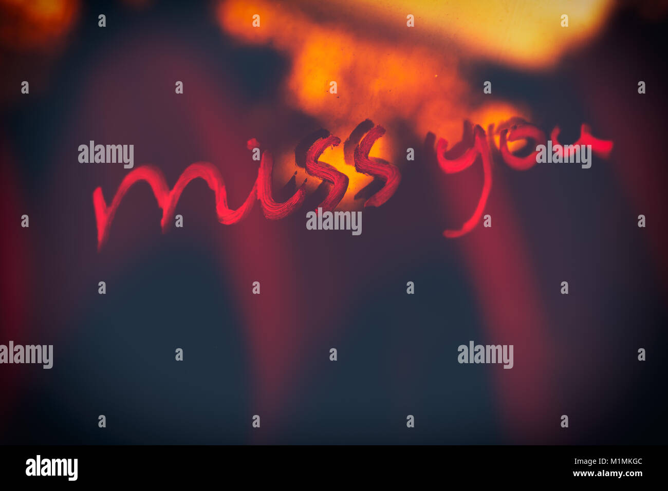 Handwritten phrase miss you, abstract dark background, loneliness and ...
