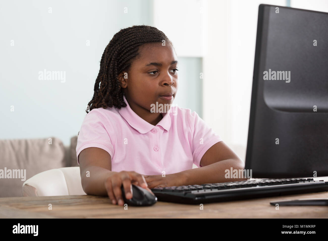 Portrait Of An African Girl Using Computer At Home Stock Photo - Alamy