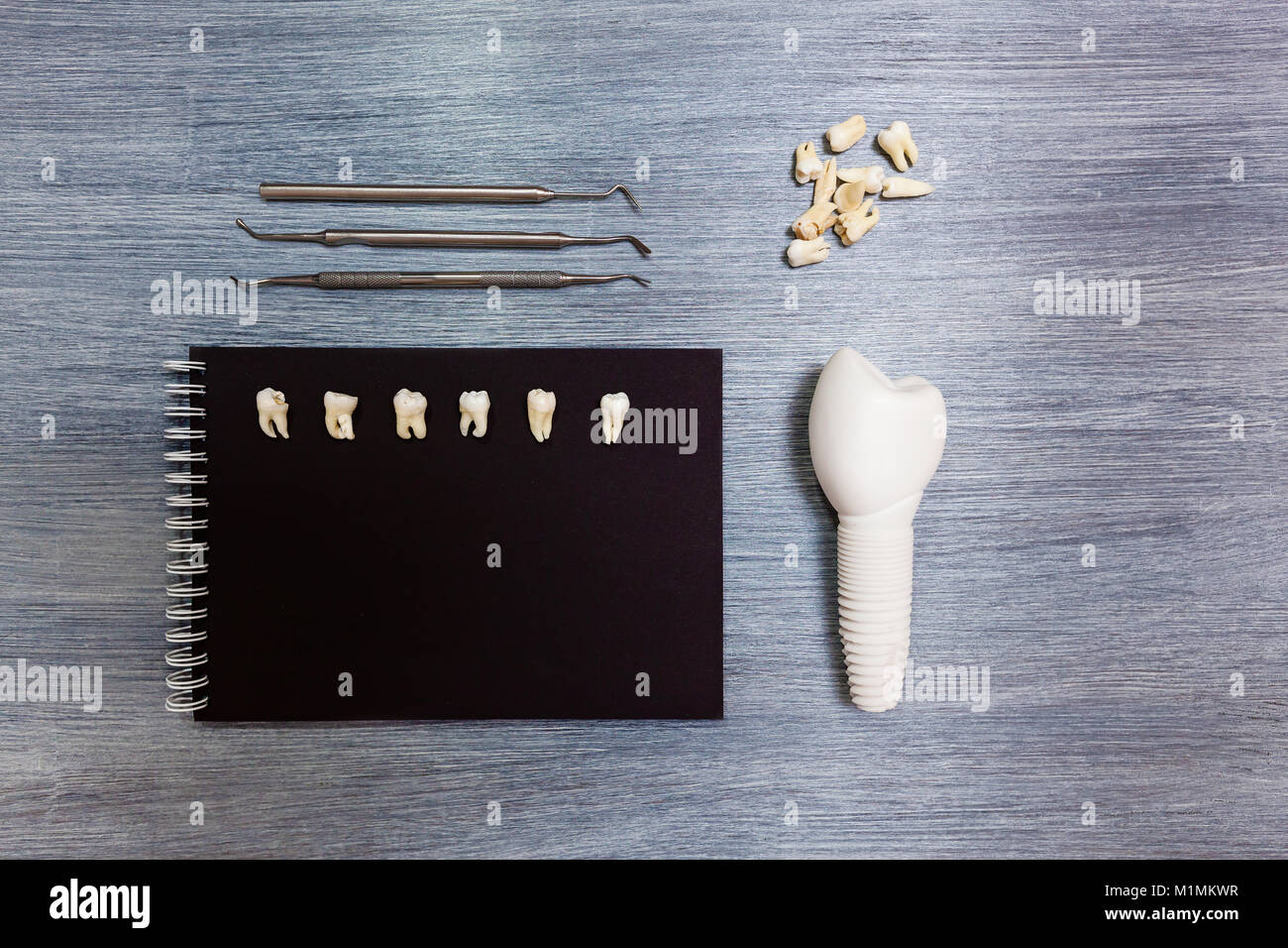 On the table lie the instruments of the dentist with black notepads and ...