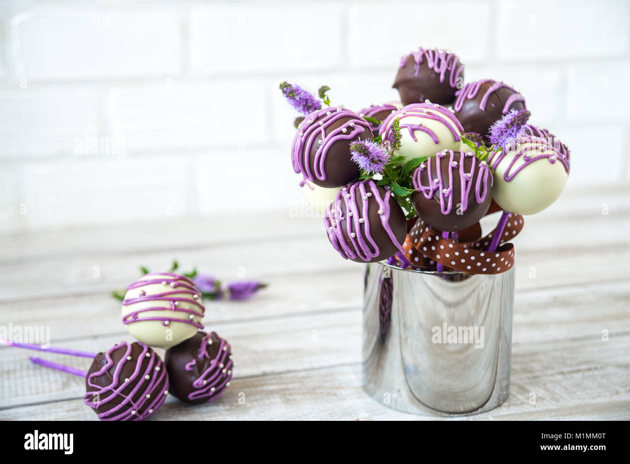 Colorful cake pops on a white wall background Stock Photo - Alamy