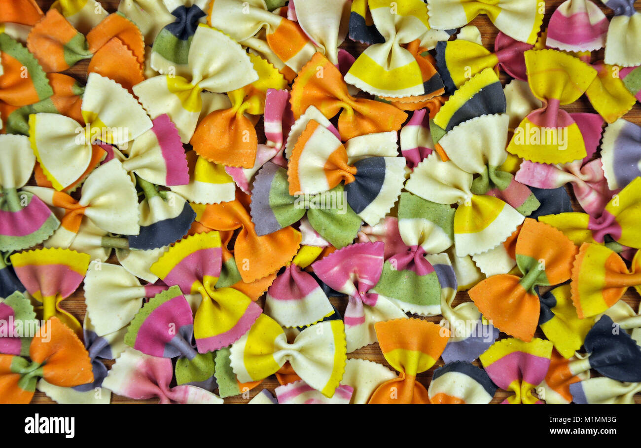 Colorful rainbos pasta bows background Stock Photo - Alamy