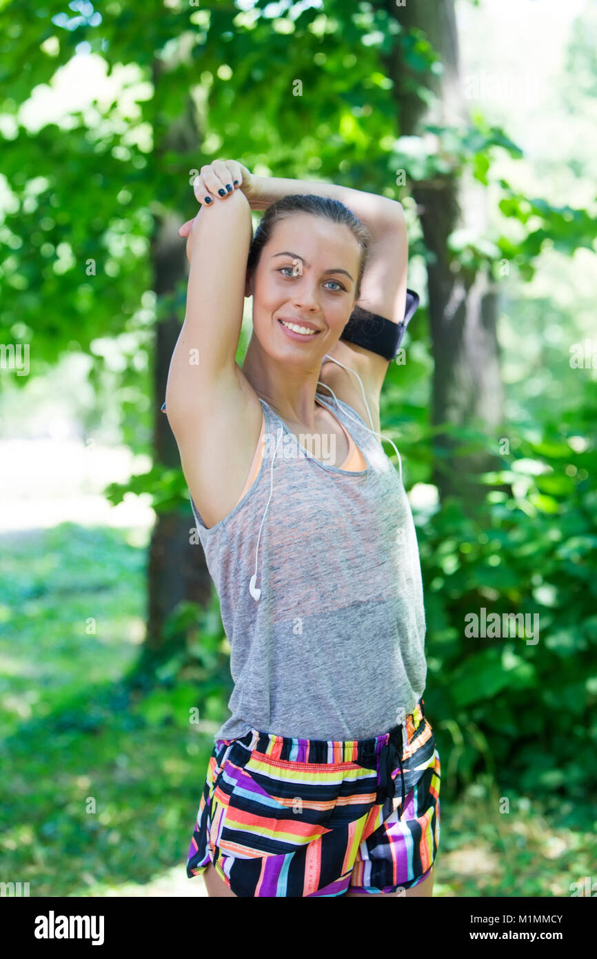 Young fitness woman runner stretching legs before run Stock Photo - Alamy