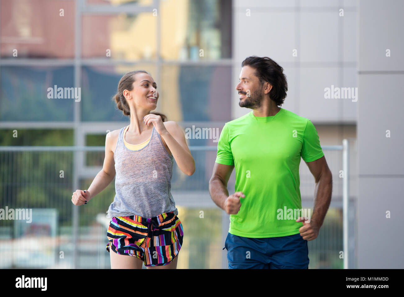 Couple running in urban enviroment at hot summer day Stock Photo - Alamy