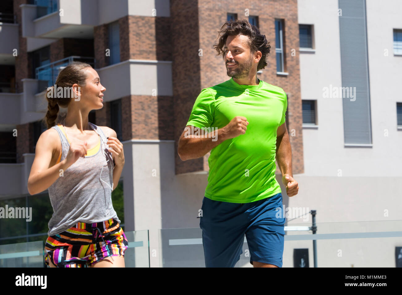 Couple running in urban enviroment at hot summer day Stock Photo - Alamy