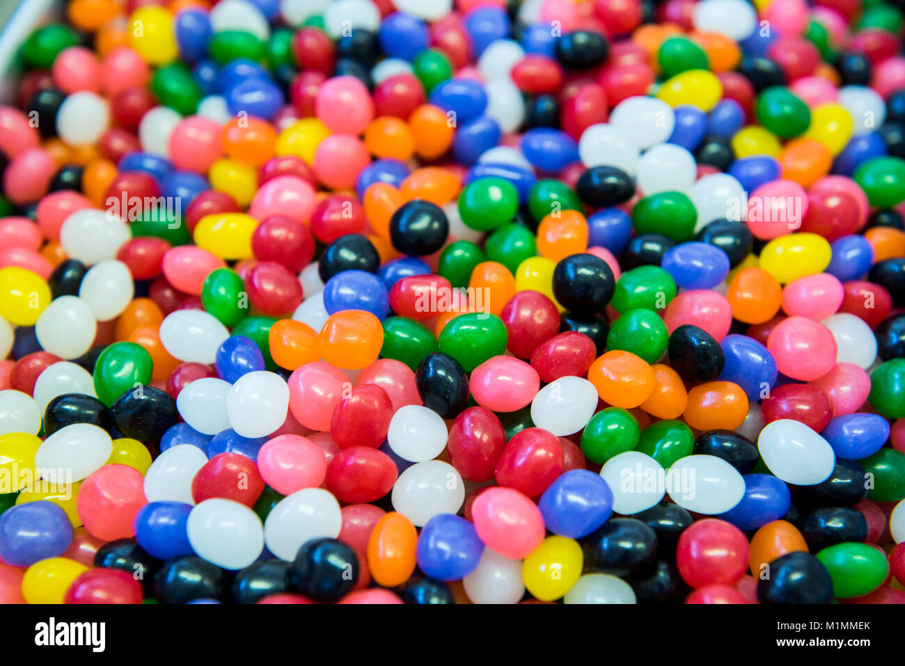 A close up shot of a lot of jelly beans in a large container Stock ...
