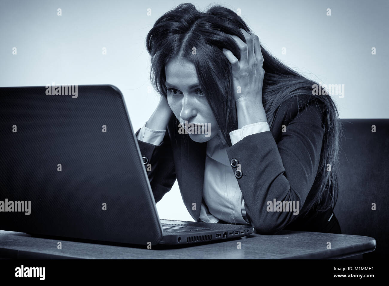 Angry and frustrated businesswoman watching her computer's screen Stock ...