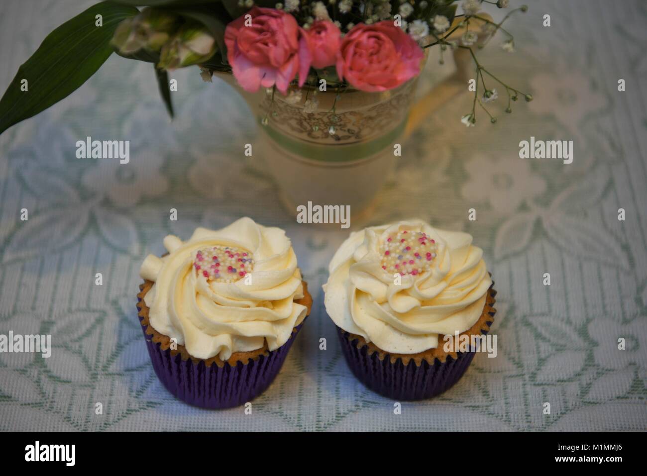 delicious vanilla cream cupcake on a vintage old fashioned lace table ...