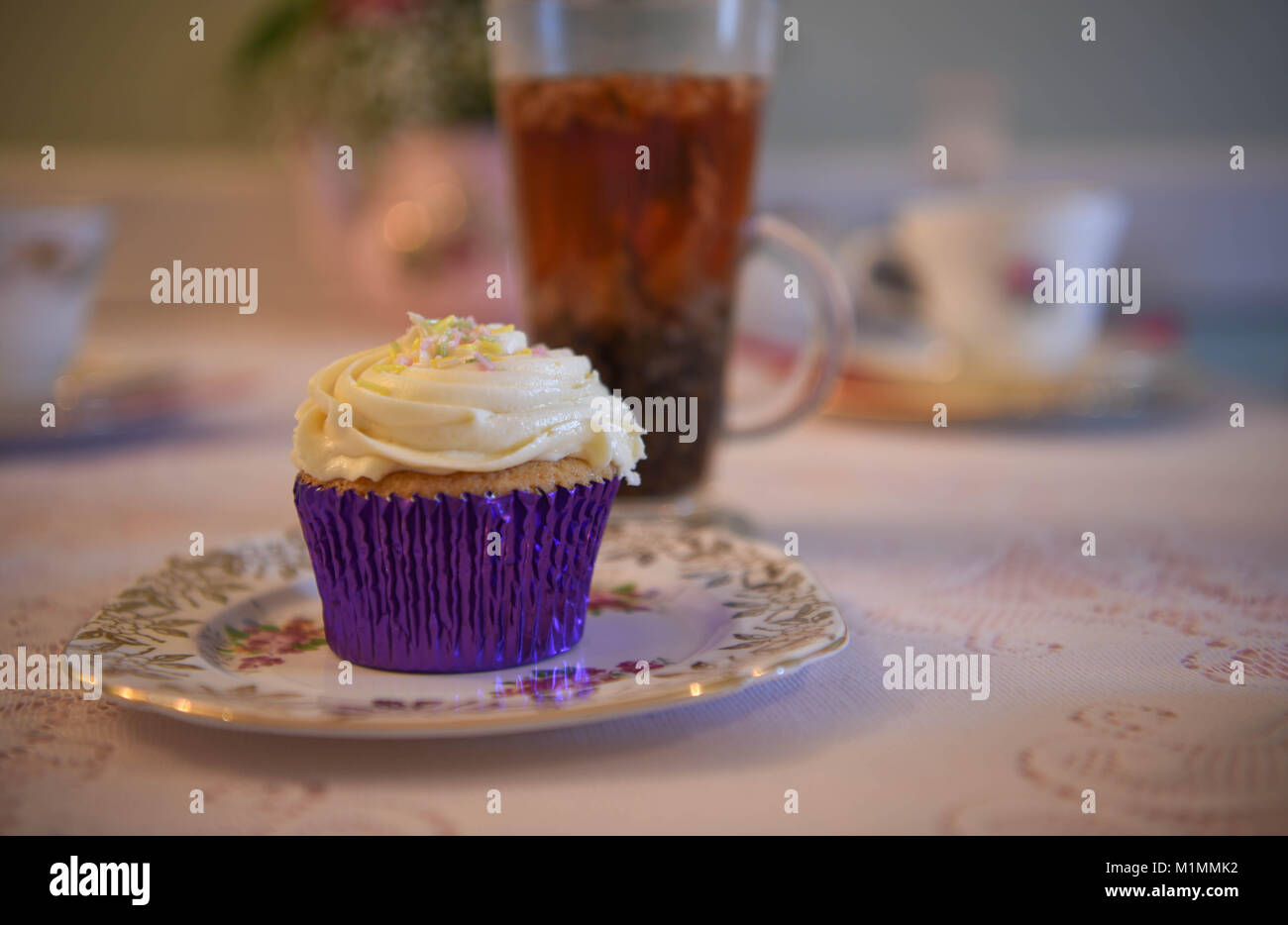 delicious vanilla cream cupcake on a vintage old fashioned lace table ...