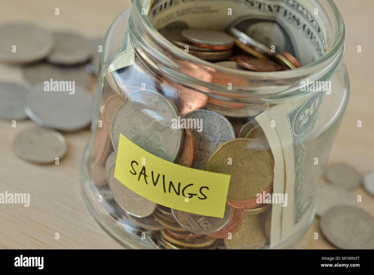 Saving money in a jar hi-res stock photography and images - Alamy