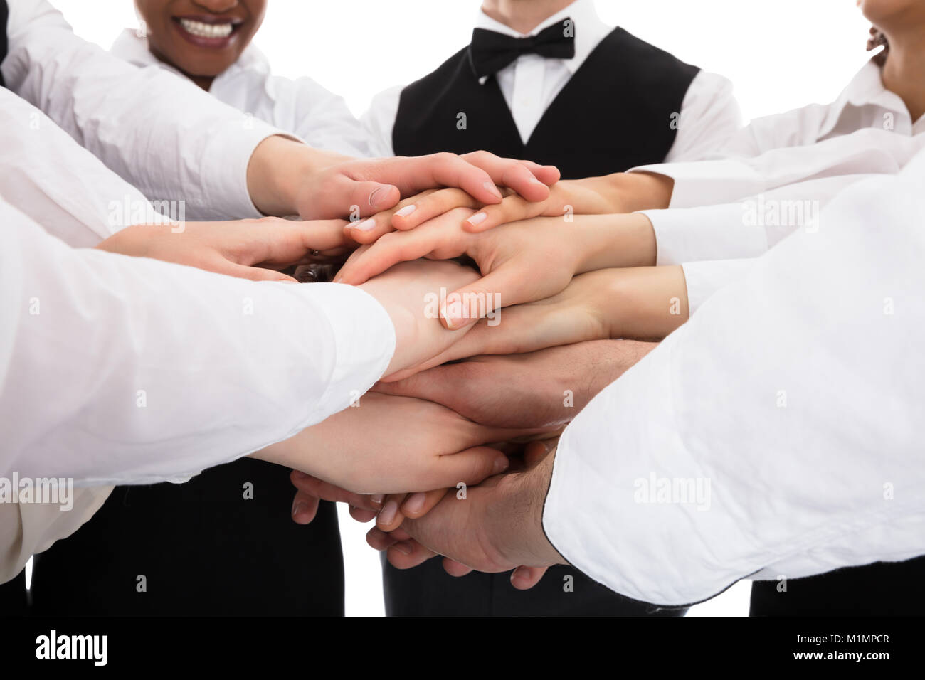 Diverse group smiling stacking hands hi-res stock photography and ...