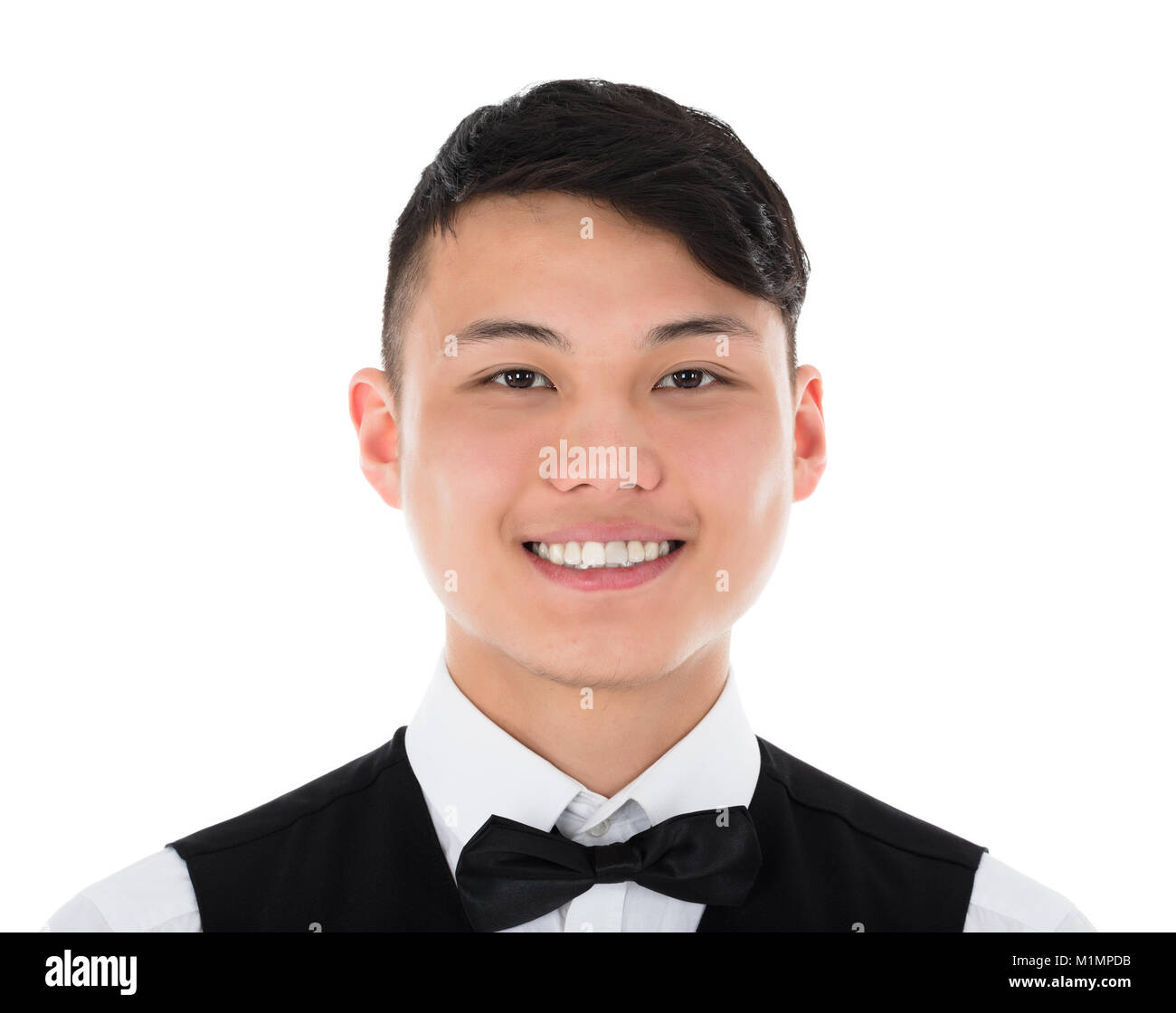 Portrait Of A Smiling Young Waiter Standing Against White Background ...