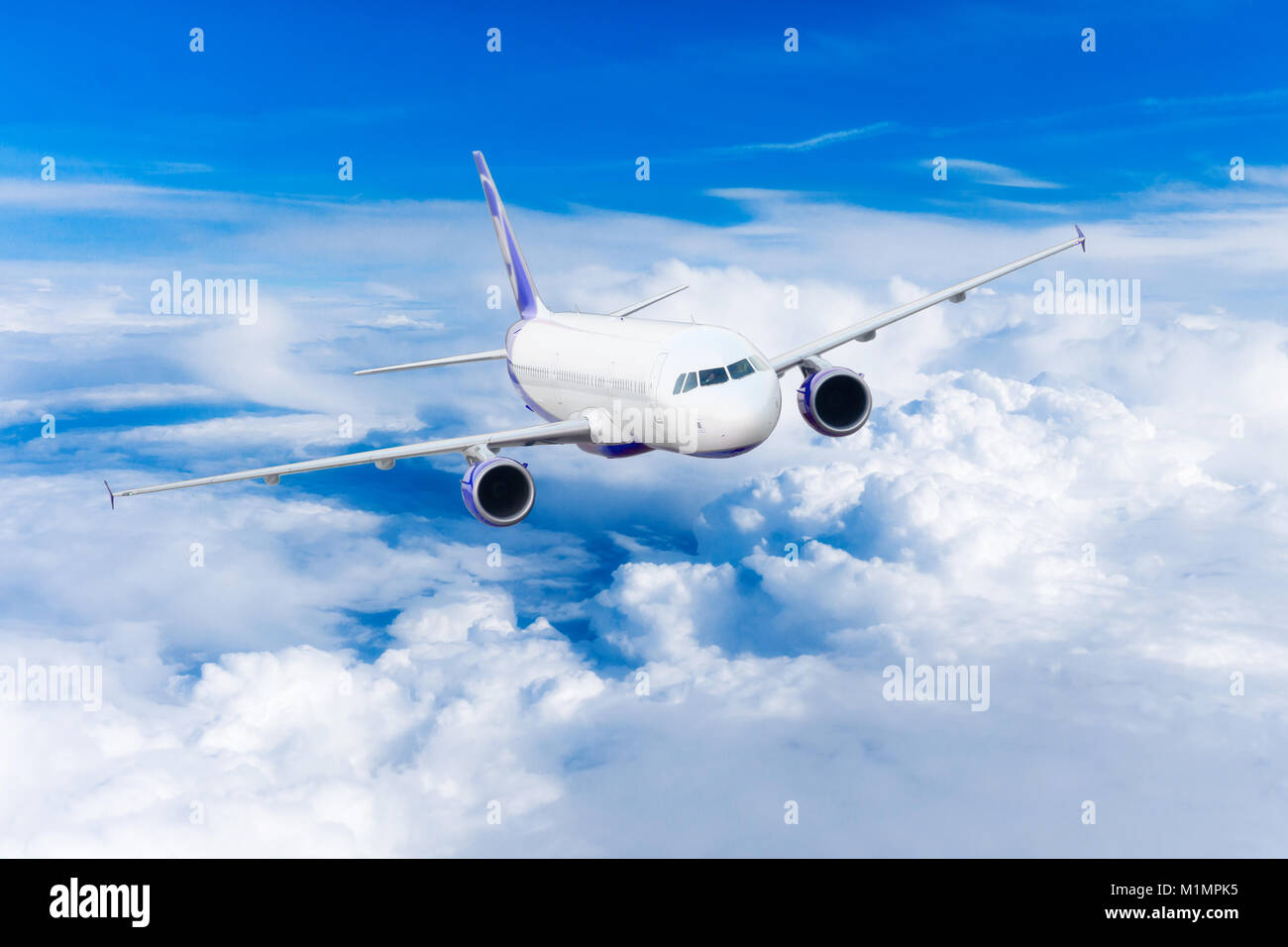 Flying of a passenger plane over the land Stock Photo - Alamy