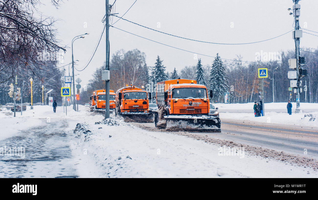 MOSCOW, RUSSIA - NOVEMBER 22, 2016: Snowplow cleans from the road snow ...