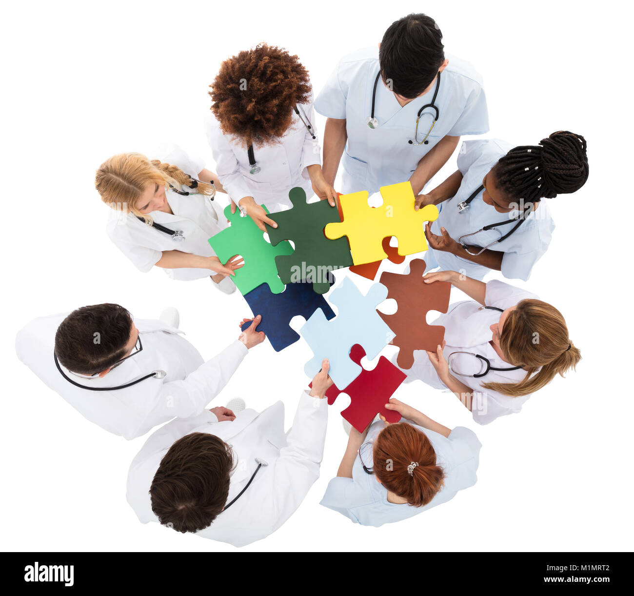 High Angle View Of Medical Team Solving Jigsaw Puzzle Stock Photo - Alamy