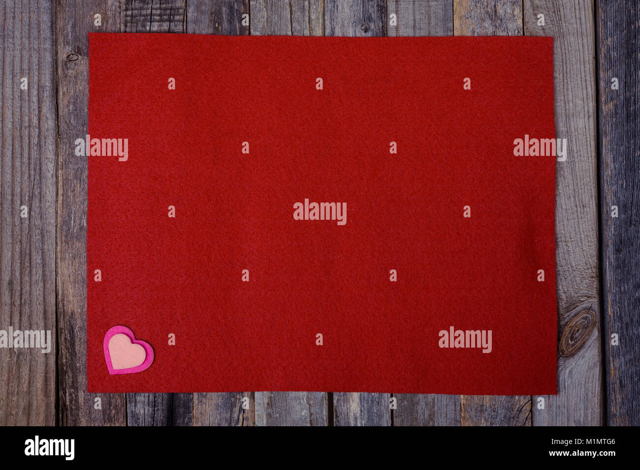 Red fleece with colorful hearts on vintage wooden background. Flat lay ...