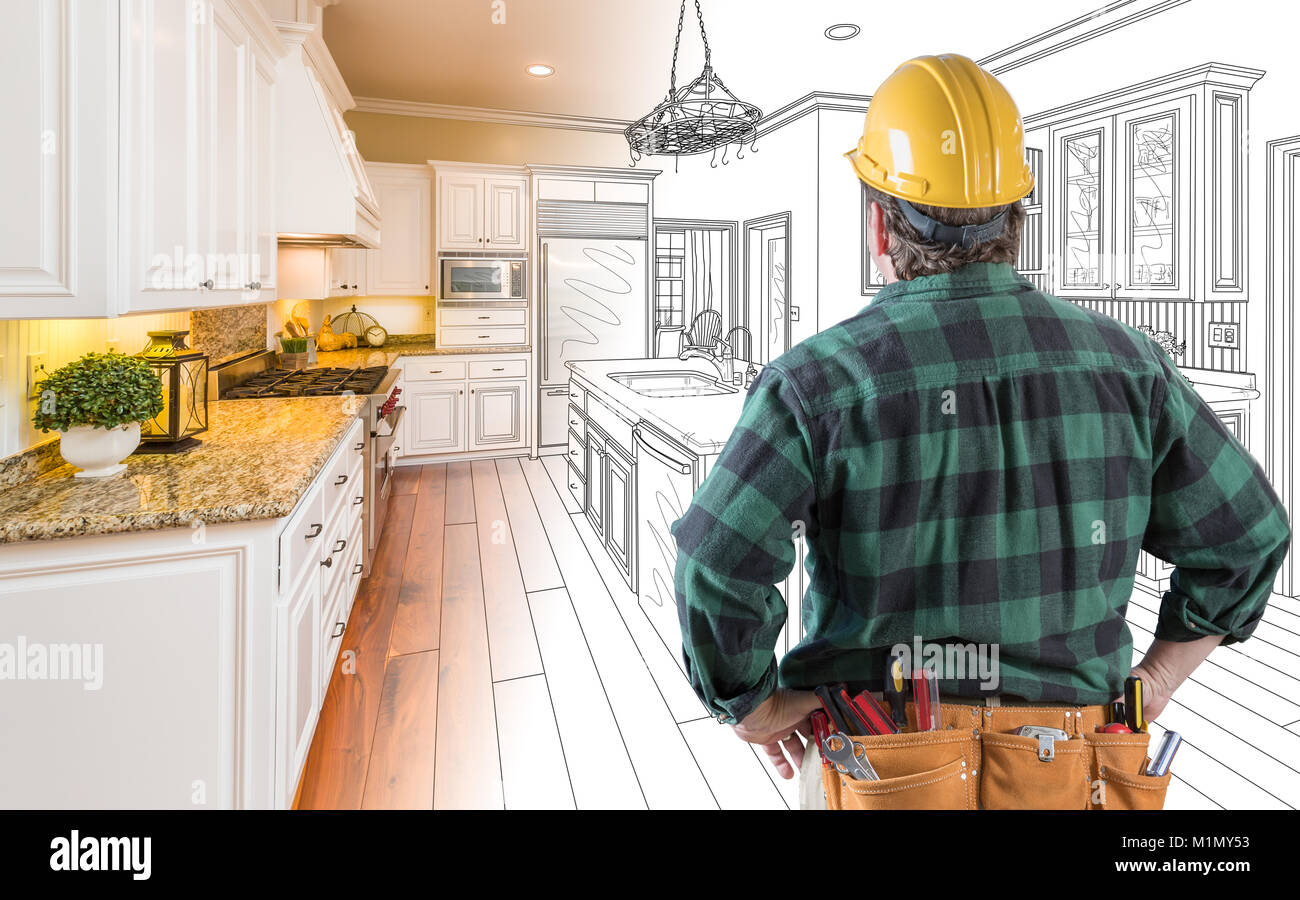 Male Contractor with Hard Hat and Tool Belt Looking At Custom Kitchen ...