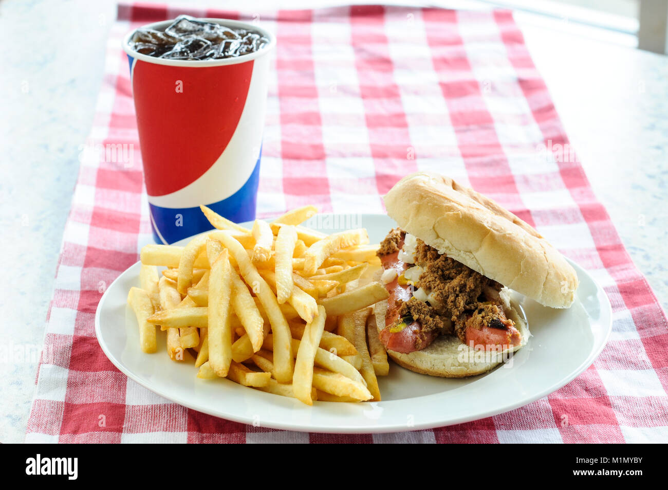 Lunch hot dog with chili, French fries and a Pepsi Stock Photo - Alamy