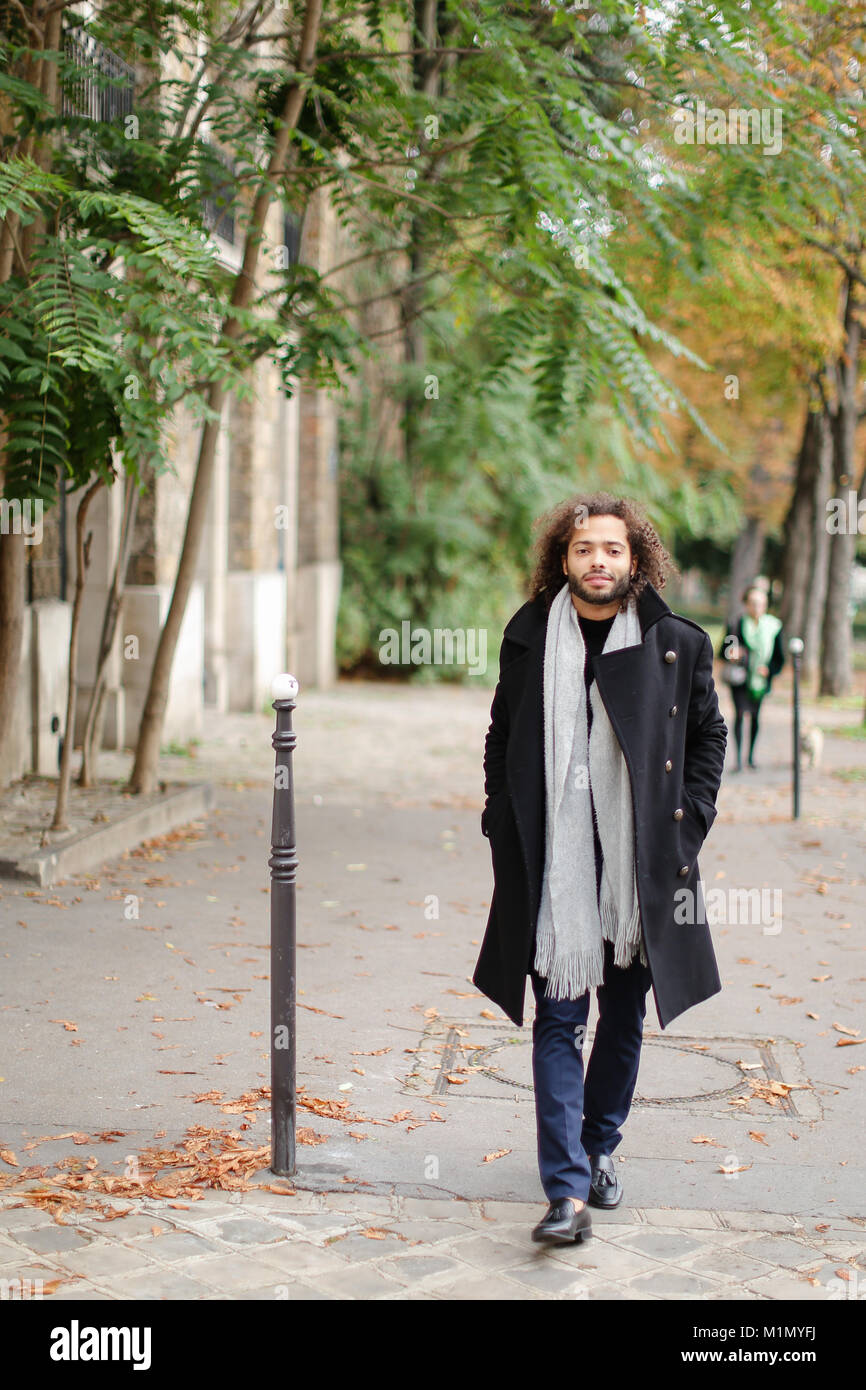 Young mix blood male person walking outside Stock Photo - Alamy
