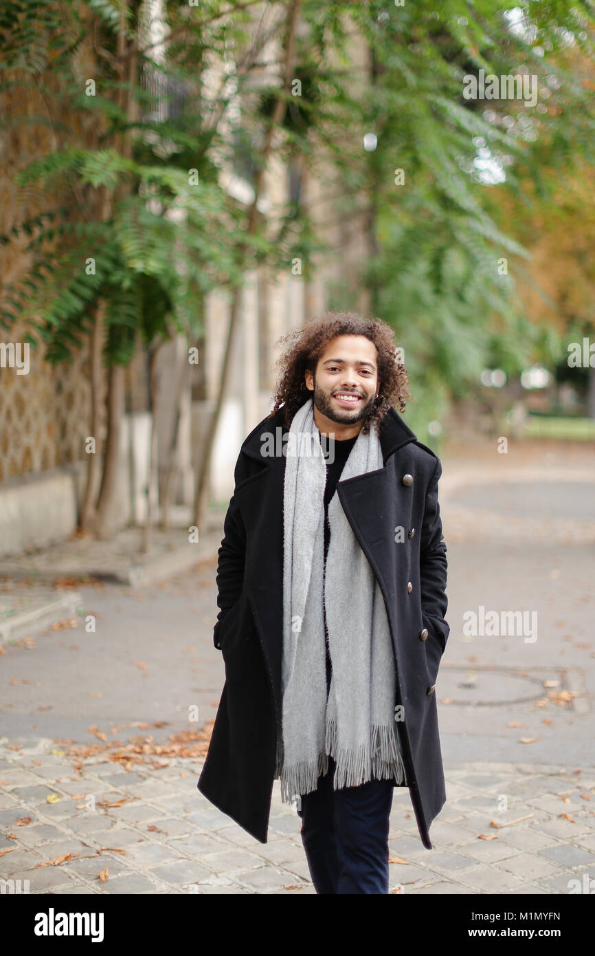 Young mix blood male person walking outside Stock Photo - Alamy