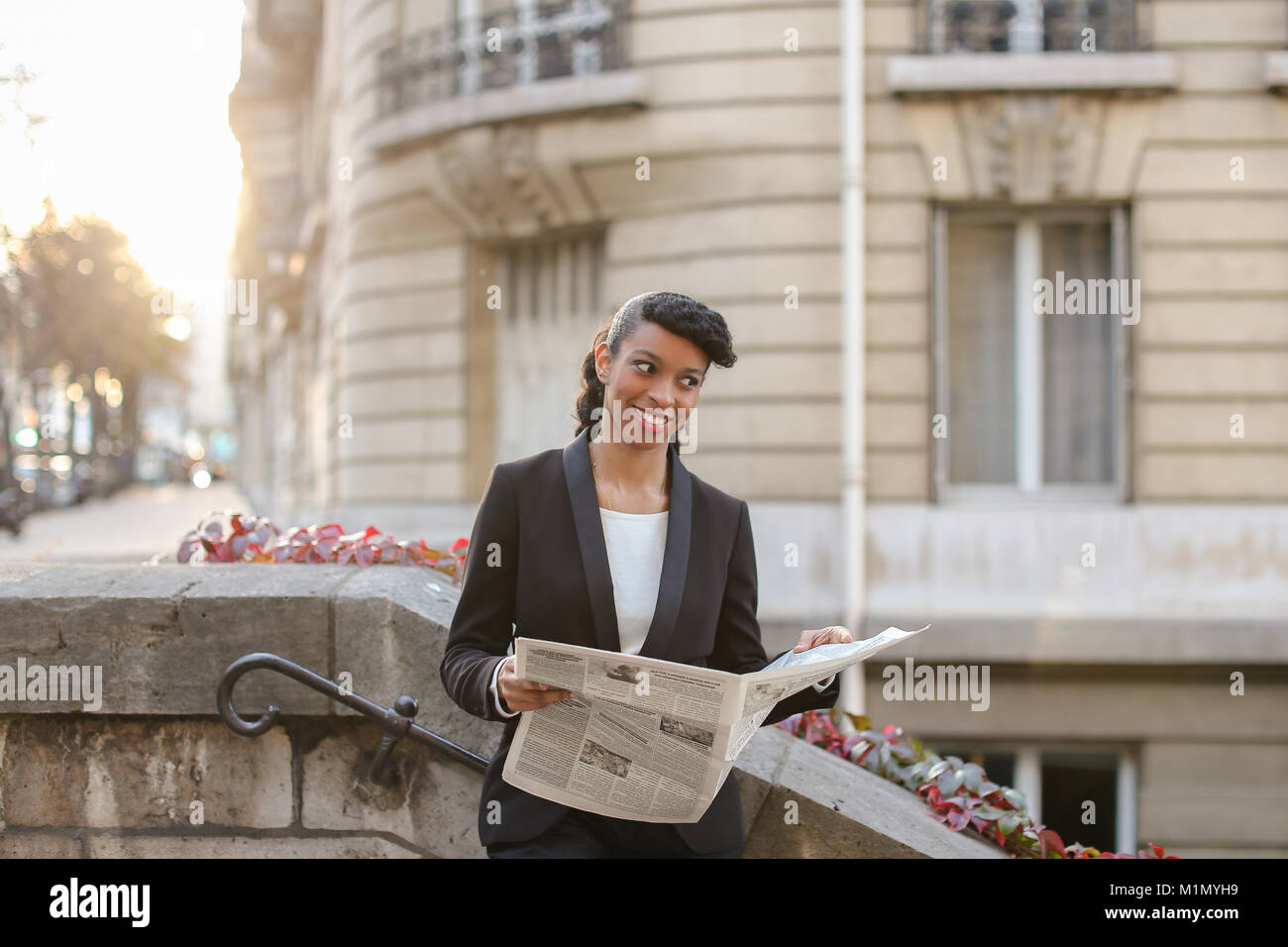 journalist reading newspaper near high building Stock Photo - Alamy
