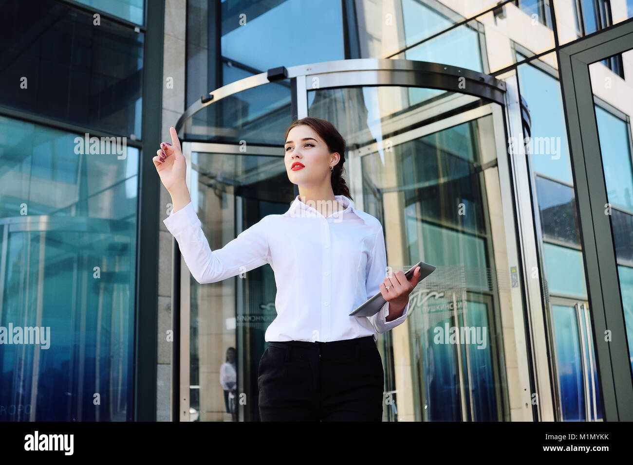 business woman clicks with an index finger on a virtual screen on the ...