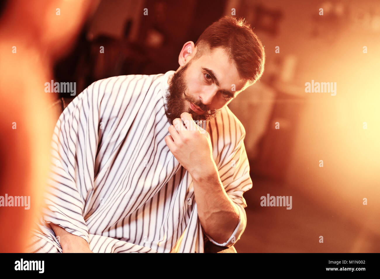 a handsome brave man with a beard in a barbershop Stock Photo - Alamy