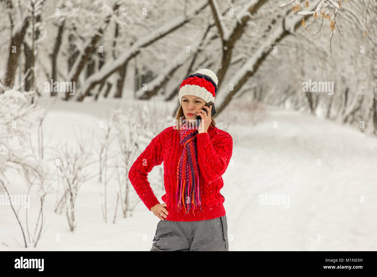 Attractive woman talking on the phone under the snow Stock Photo - Alamy
