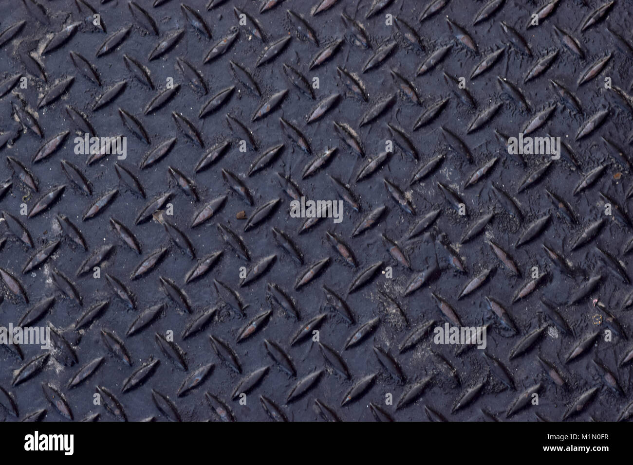 Black metal diamond plate abstract closeup texture background with dirt ...