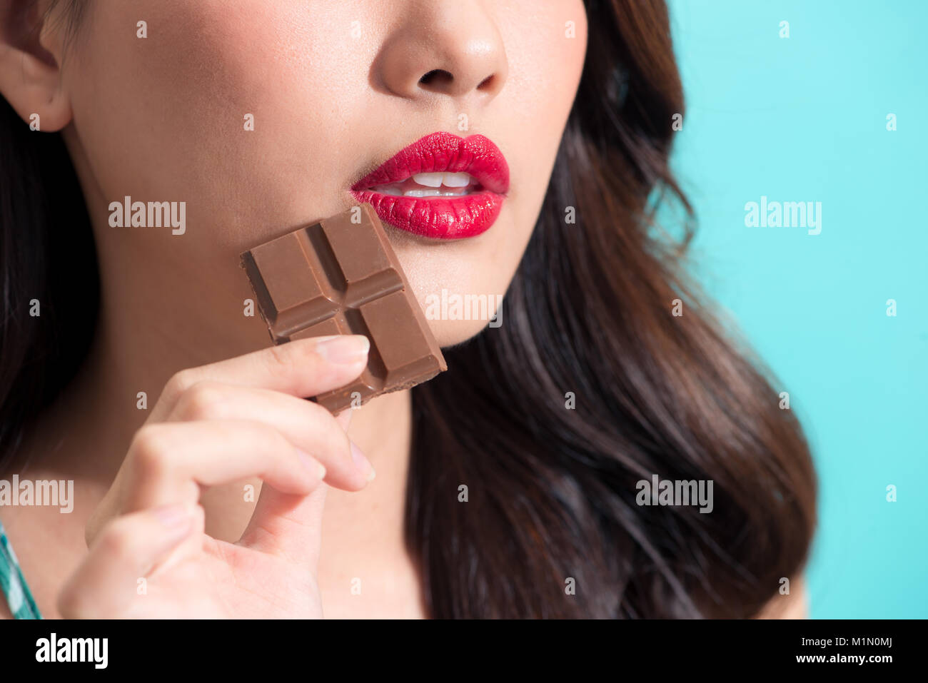 Closeup of the beautiful girl eating chocolate Stock Photo - Alamy