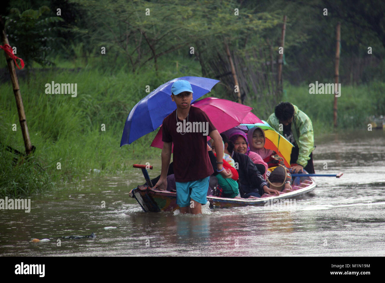 Residents crossed flood puddles in Baleendah, Bandung, West Java ...