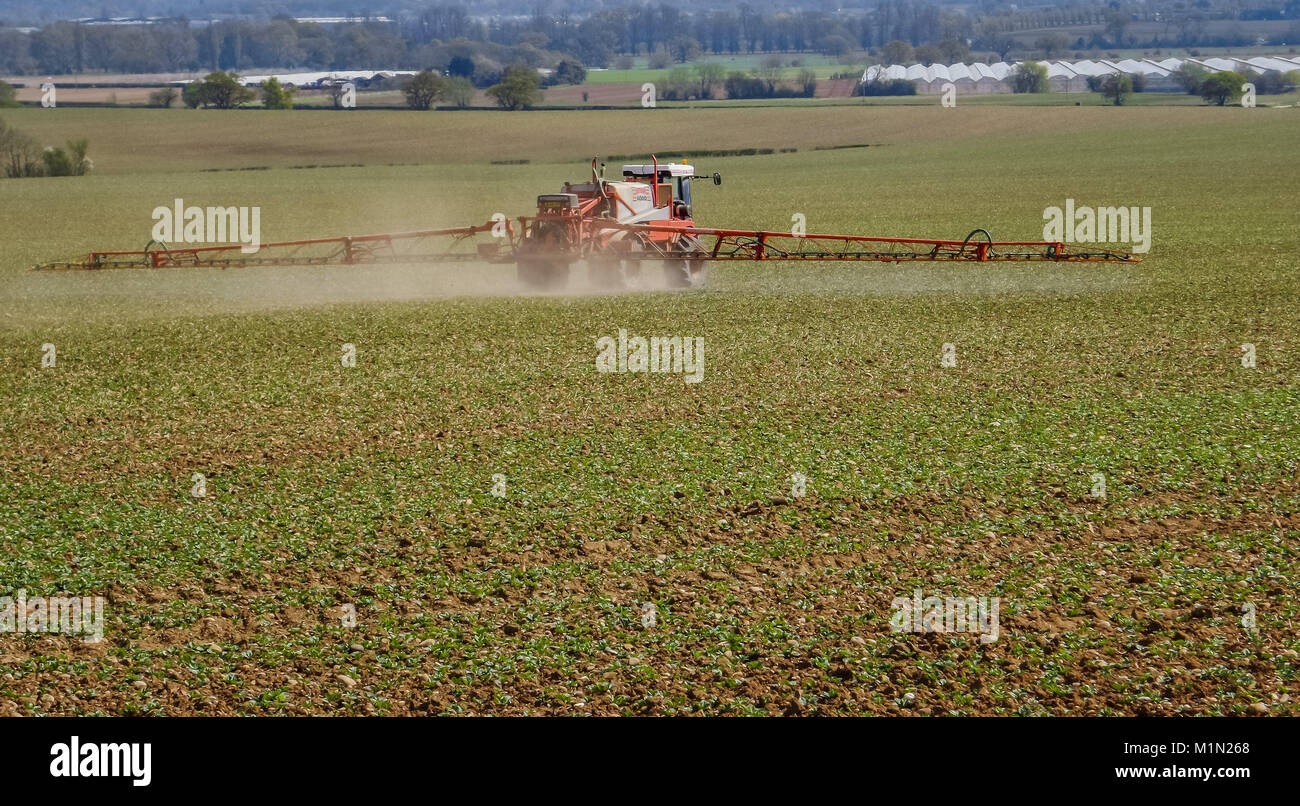 tractor crop spraying a field Stock Photo - Alamy