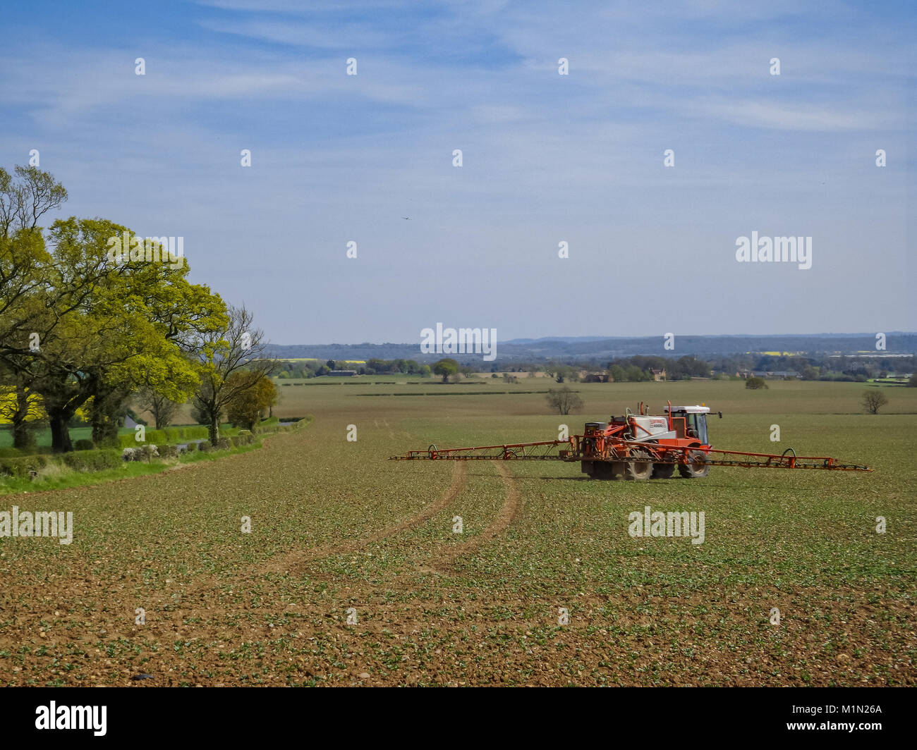tractor crop spraying a field Stock Photo - Alamy
