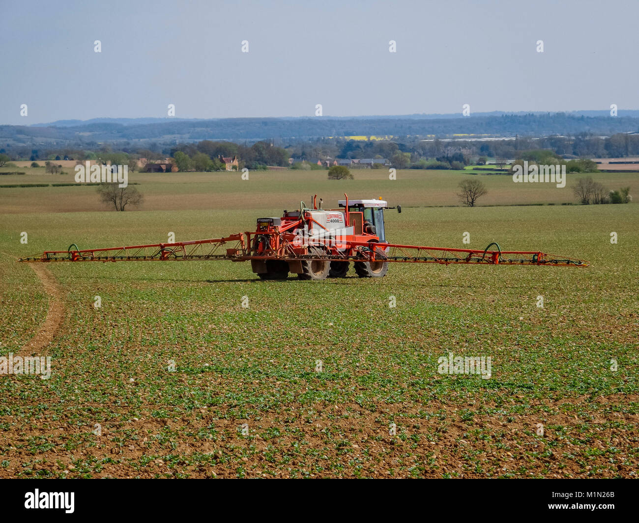 tractor crop spraying a field Stock Photo - Alamy