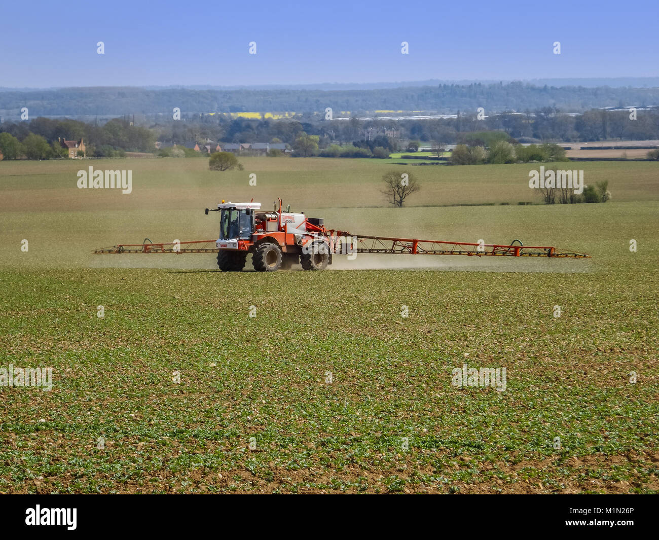 tractor crop spraying a field Stock Photo - Alamy