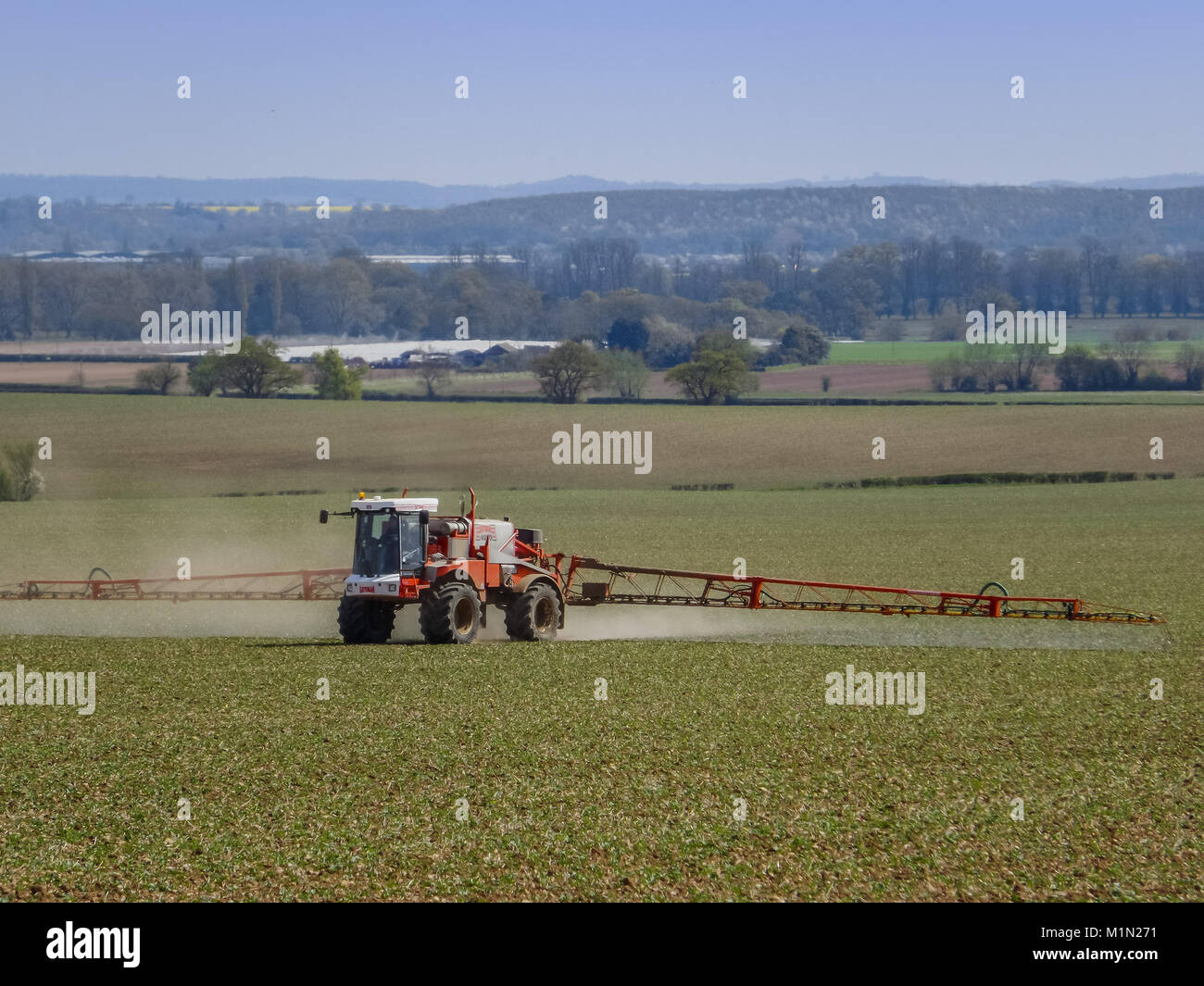 tractor crop spraying a field Stock Photo - Alamy