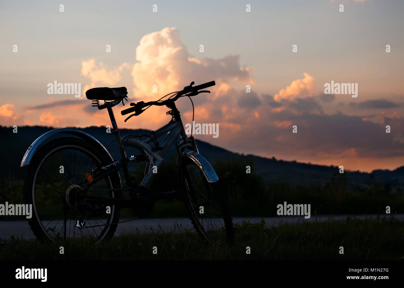 road and bike into the stunning sunset Stock Photo - Alamy