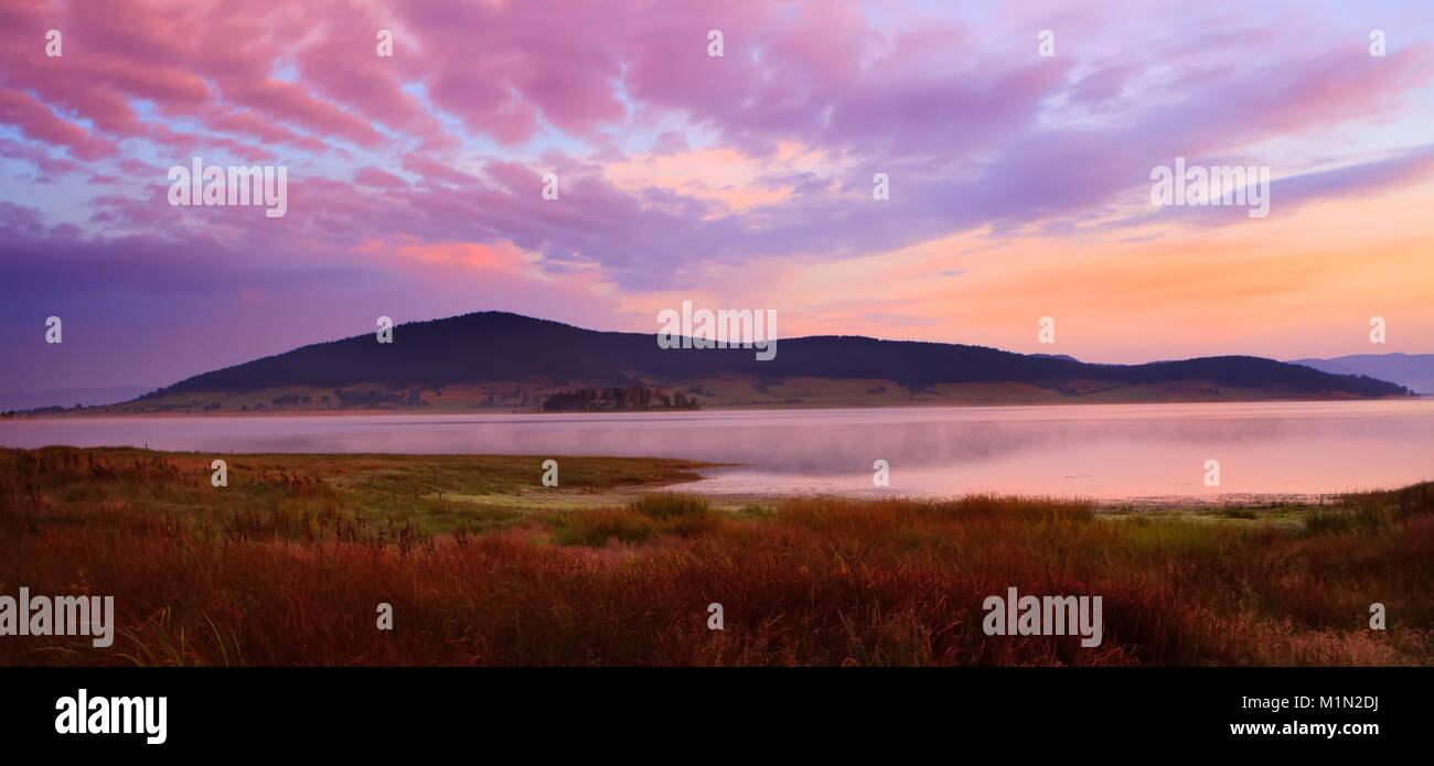 Beautiful morning with rising sun on lake, pink dominant colors Stock ...