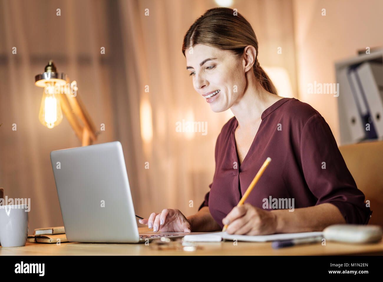 Cheerful woman doing her work with pleasure Stock Photo - Alamy