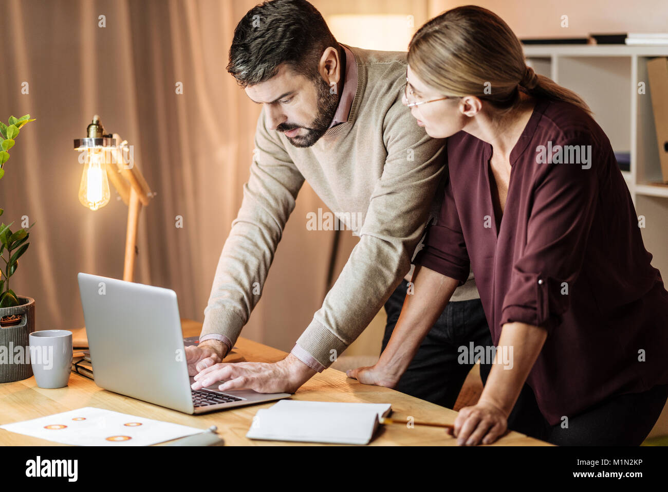 Concentrated bearded man using computer Stock Photo - Alamy