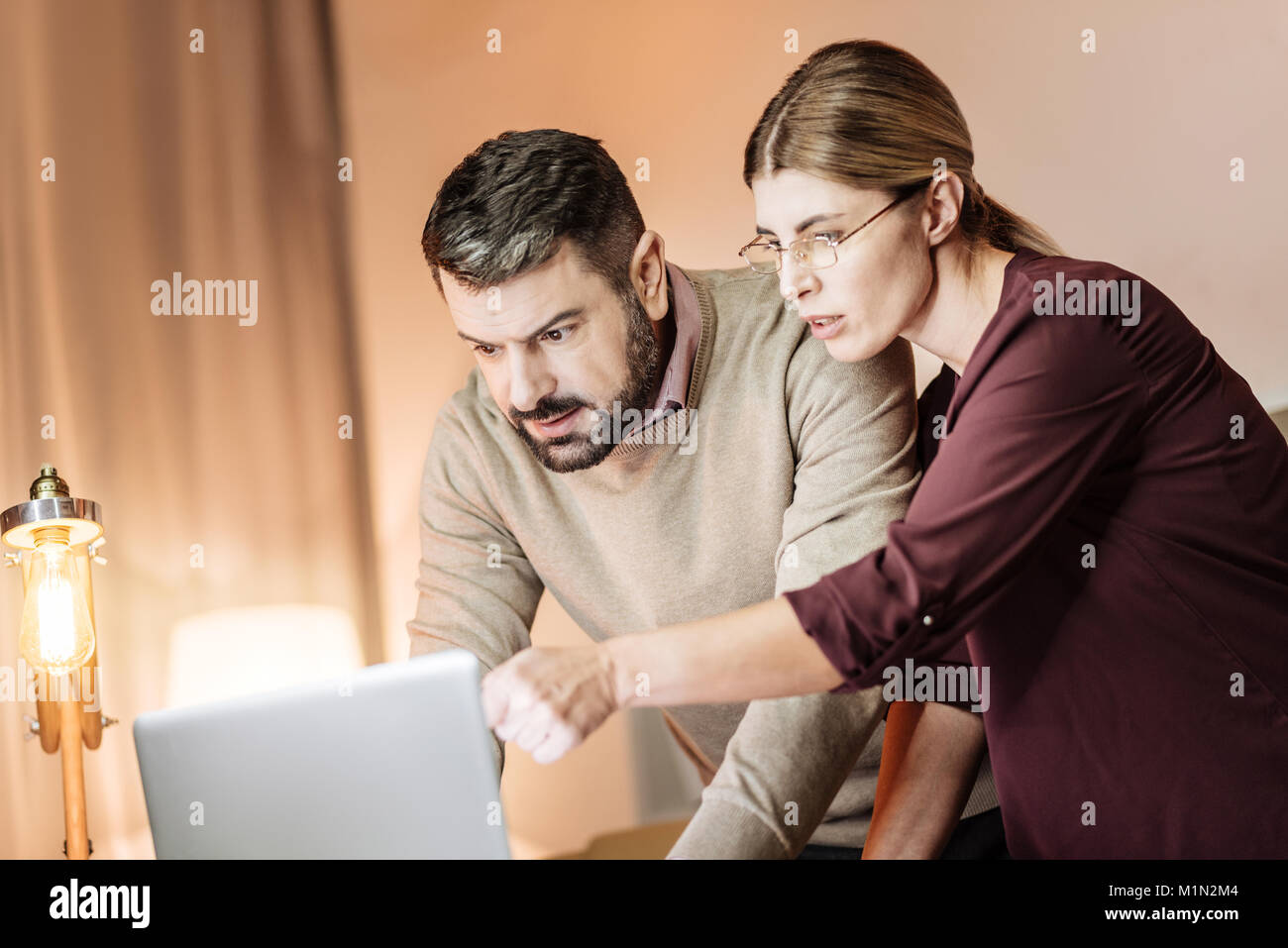 Serious male person looking at computer Stock Photo - Alamy
